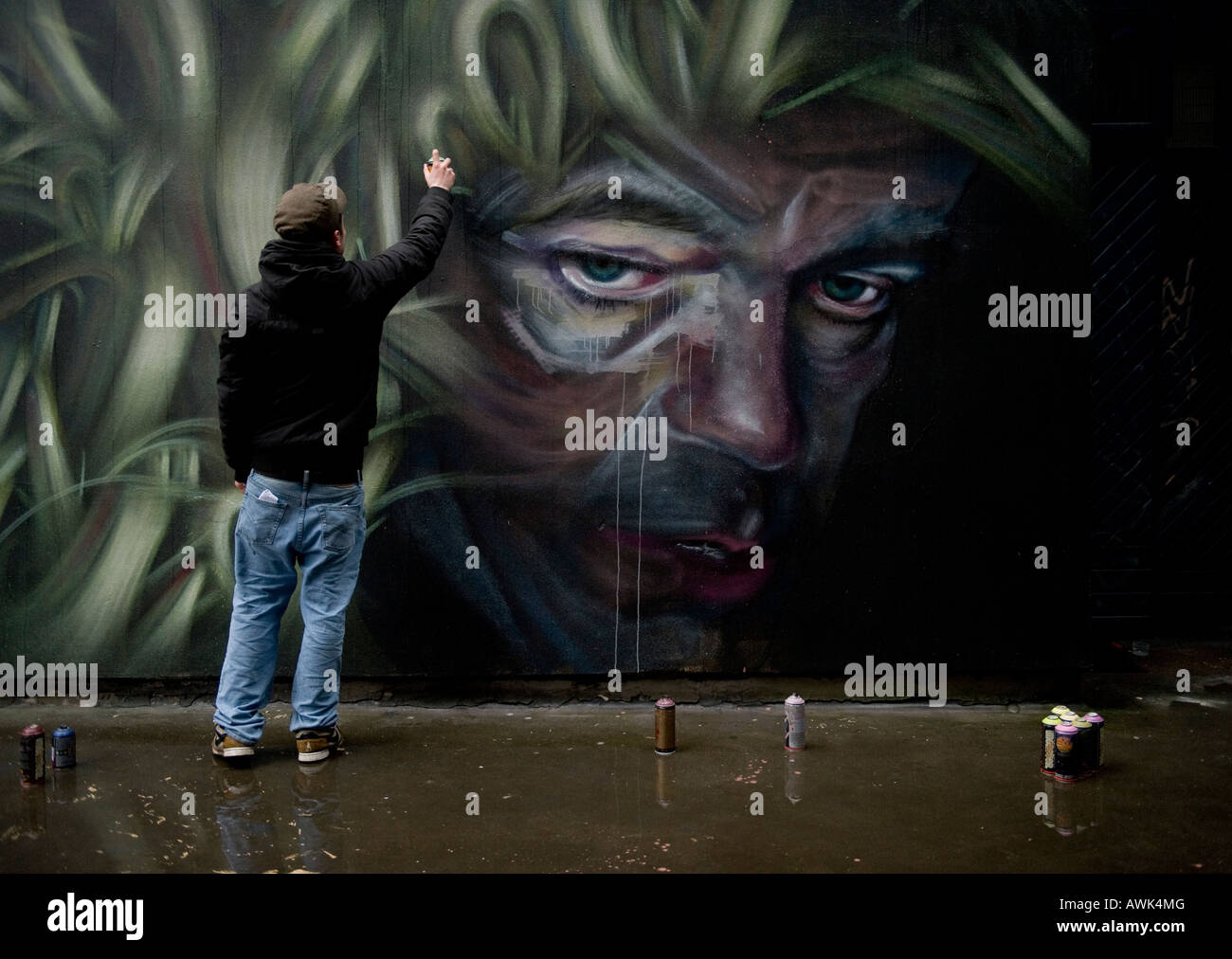 Graffiti Artist sprays mural on a wall dedicated to graffiti Art ...