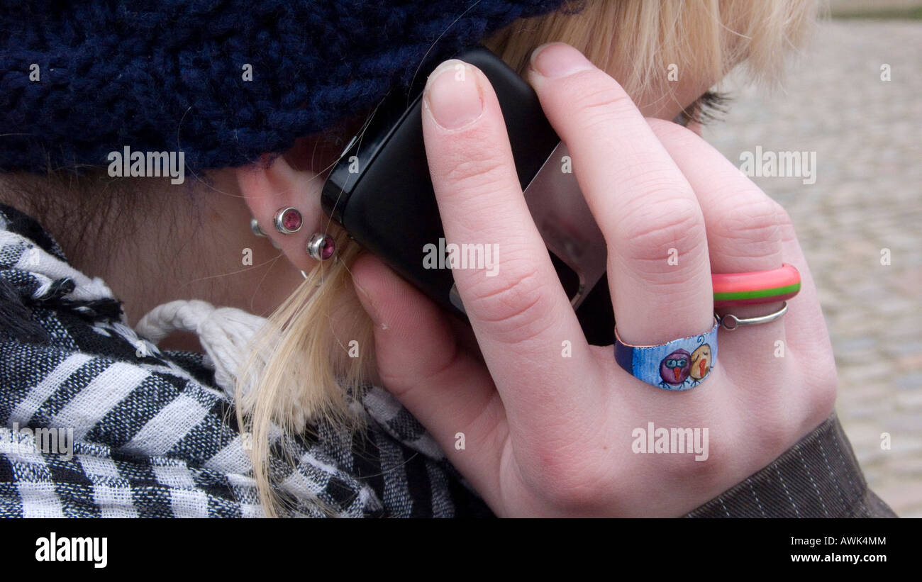 Detail of blonde girl with colorful rings talking on mobile phone Stock ...