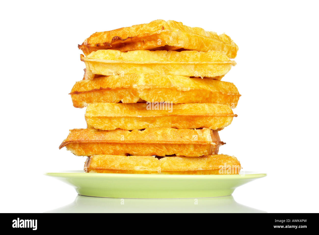 A big stack of waffles on the green plate reflected on white background ...