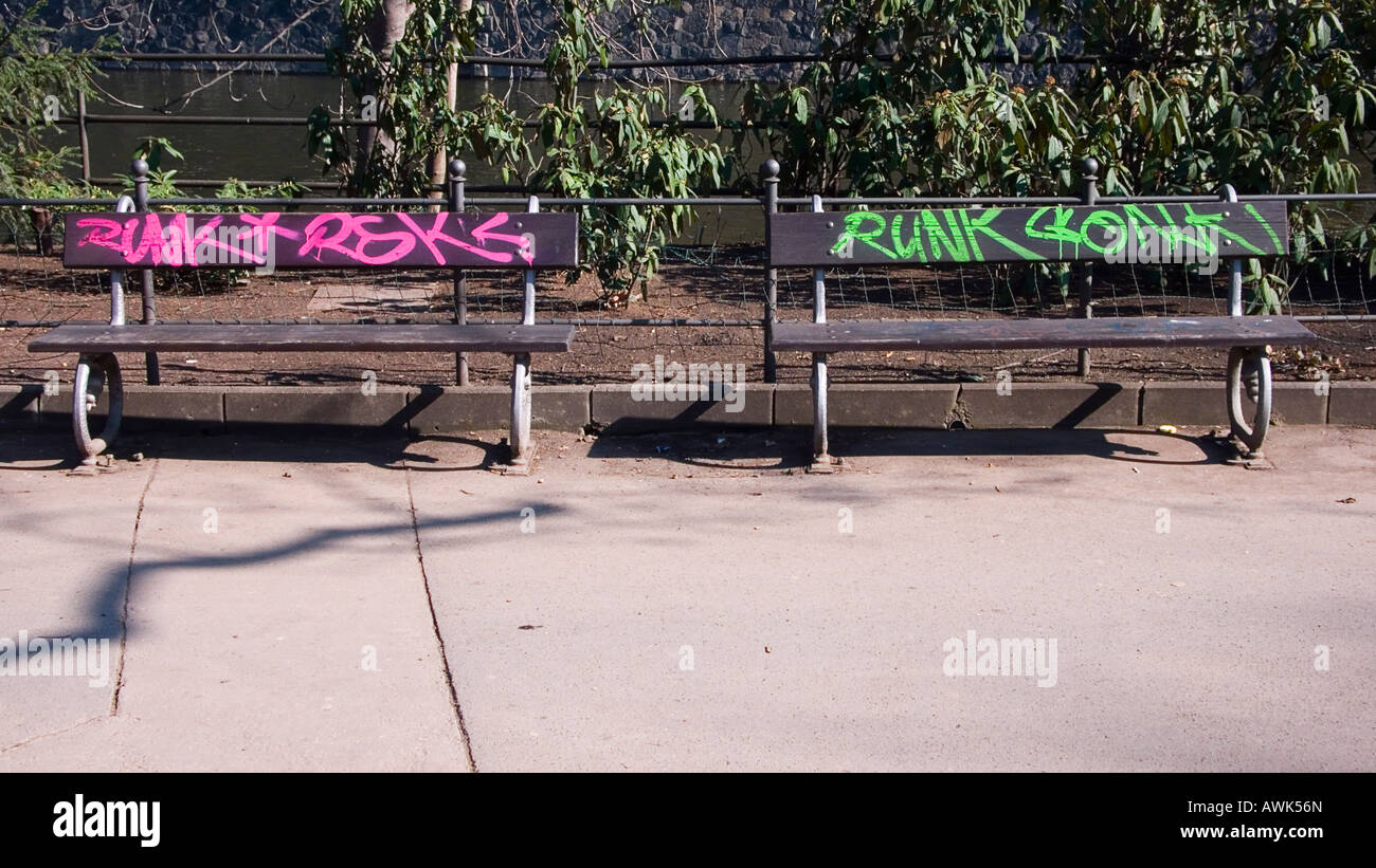 Pink and green graffiti on benches Stock Photo - Alamy