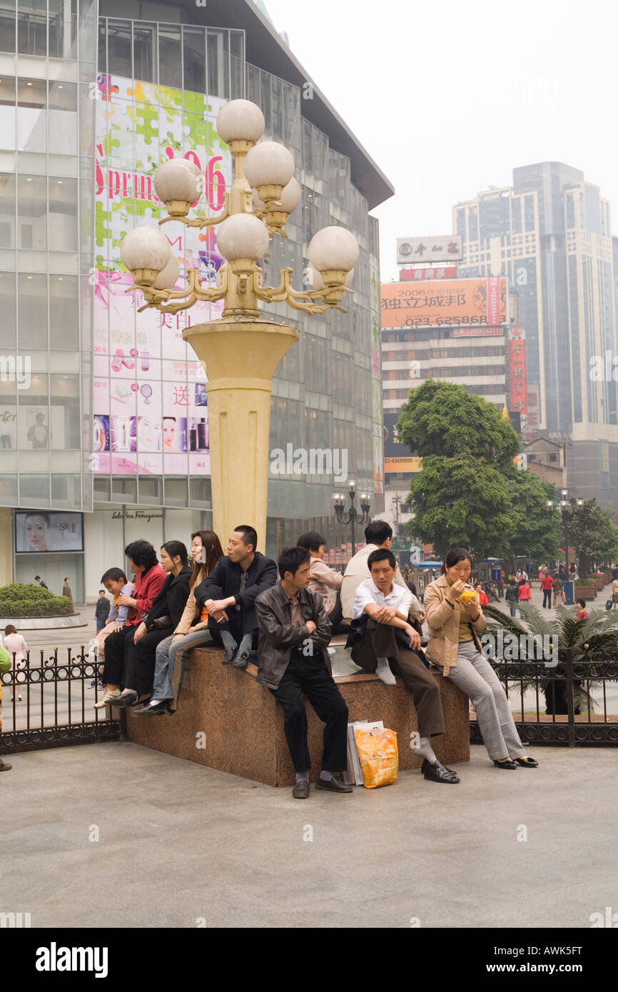 People sitting under a lamp post, Chongqing, The People's Republic of ...