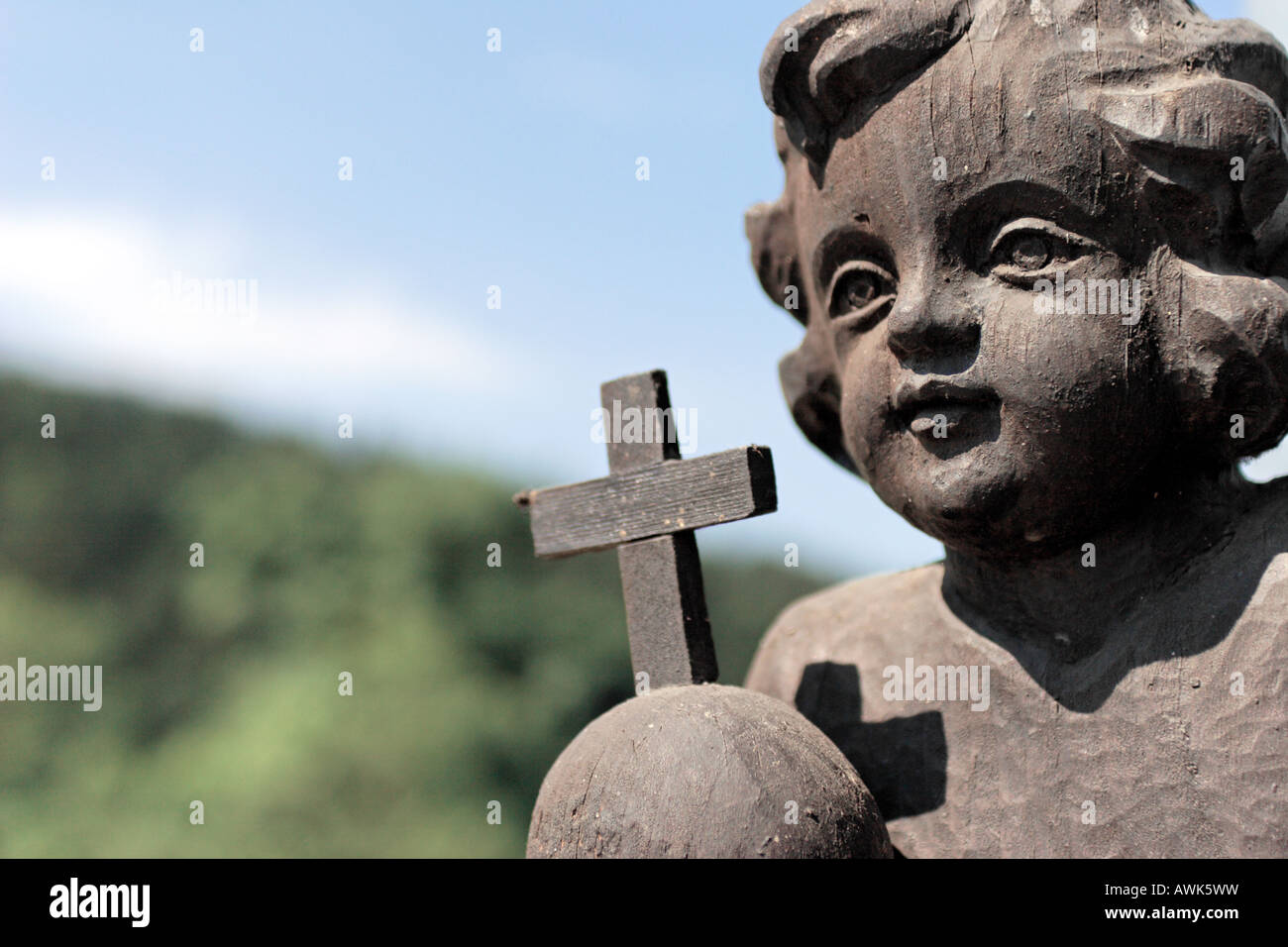 Cherub holding an orb with a cross on it Stock Photo - Alamy