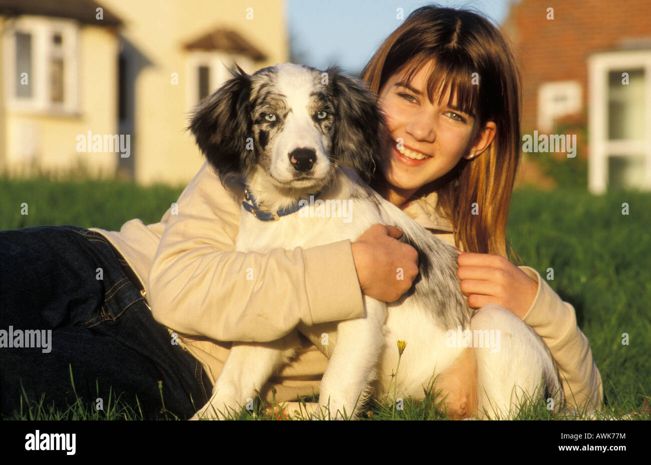 portrait teenage girl lying on lawn cuddling young pet sheepdog Stock ...