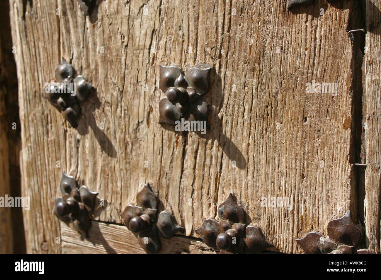 Brown wooden door. Wood and nails. Decorated Stock Photo - Alamy