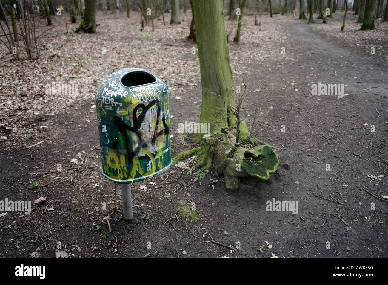 Picture of a vandalized garbage can in the woods Stock Photo - Alamy