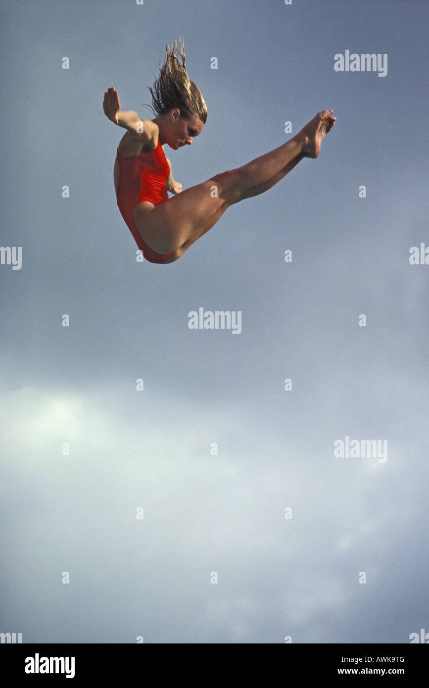 Female diver flying through the air Stock Photo - Alamy