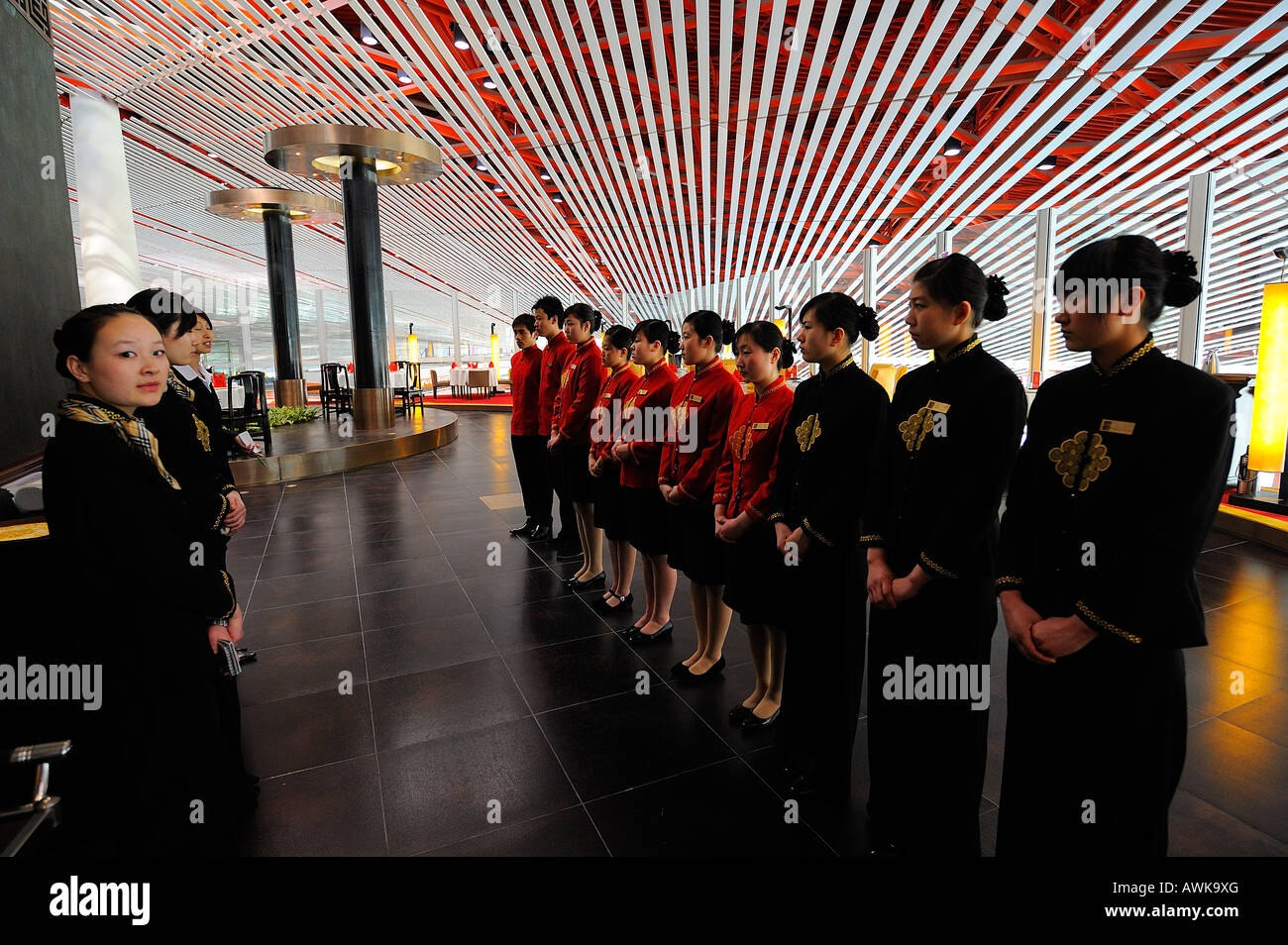 Waiters and waitresses line up at a restaurant to listen to manager's ...