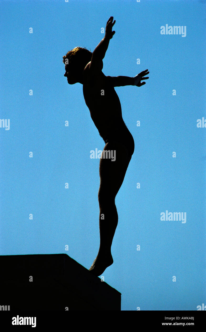 Silhouette of male diver about to dive off the 10m platform Stock Photo ...
