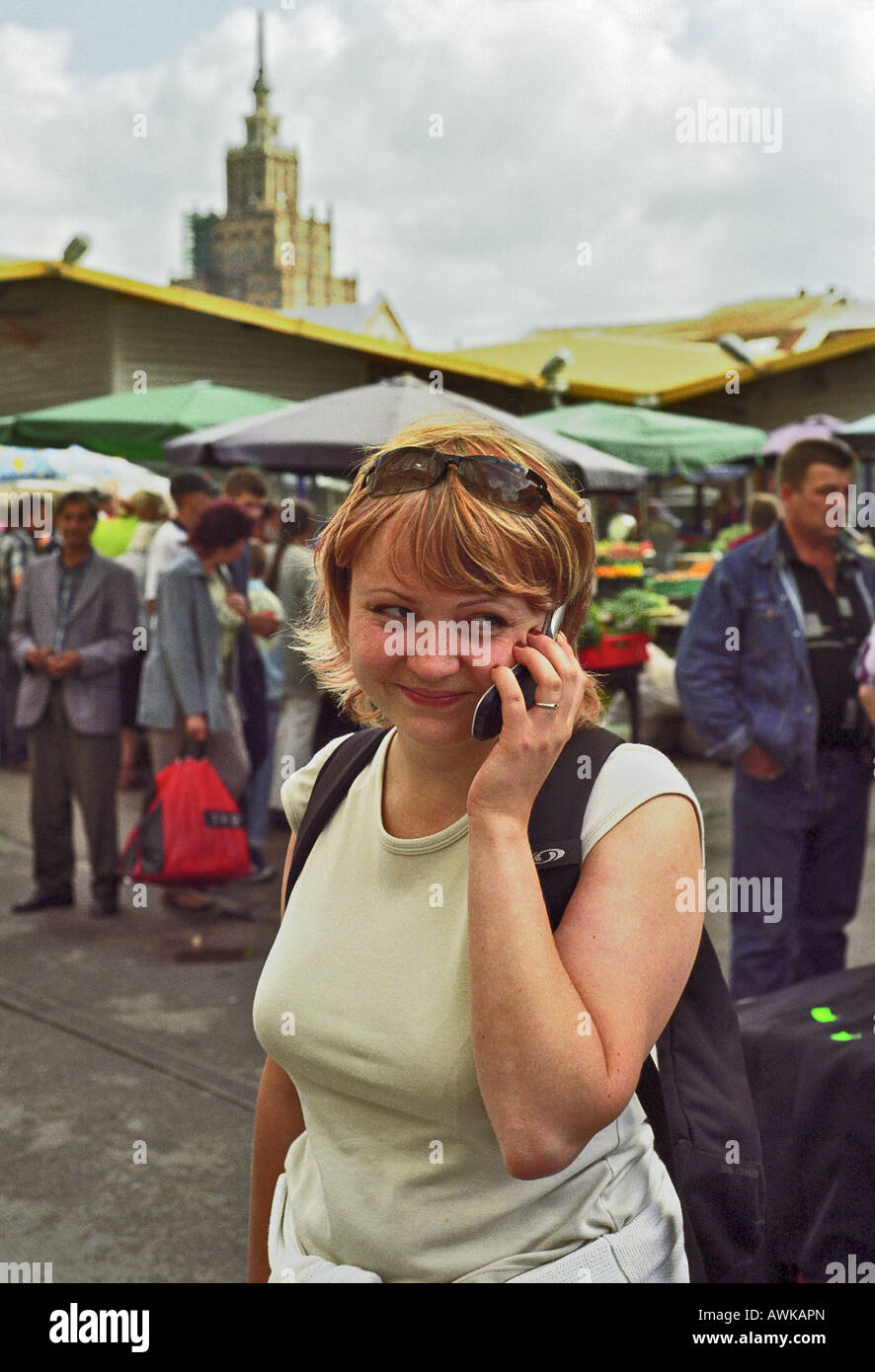 Young woman with mobile phone at the central marketplace in Riga ...