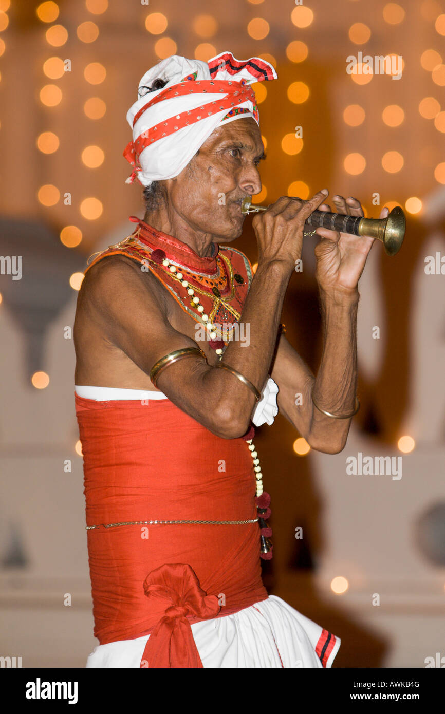 An old man plays a traditional instrument in the Kandy perahera Stock ...