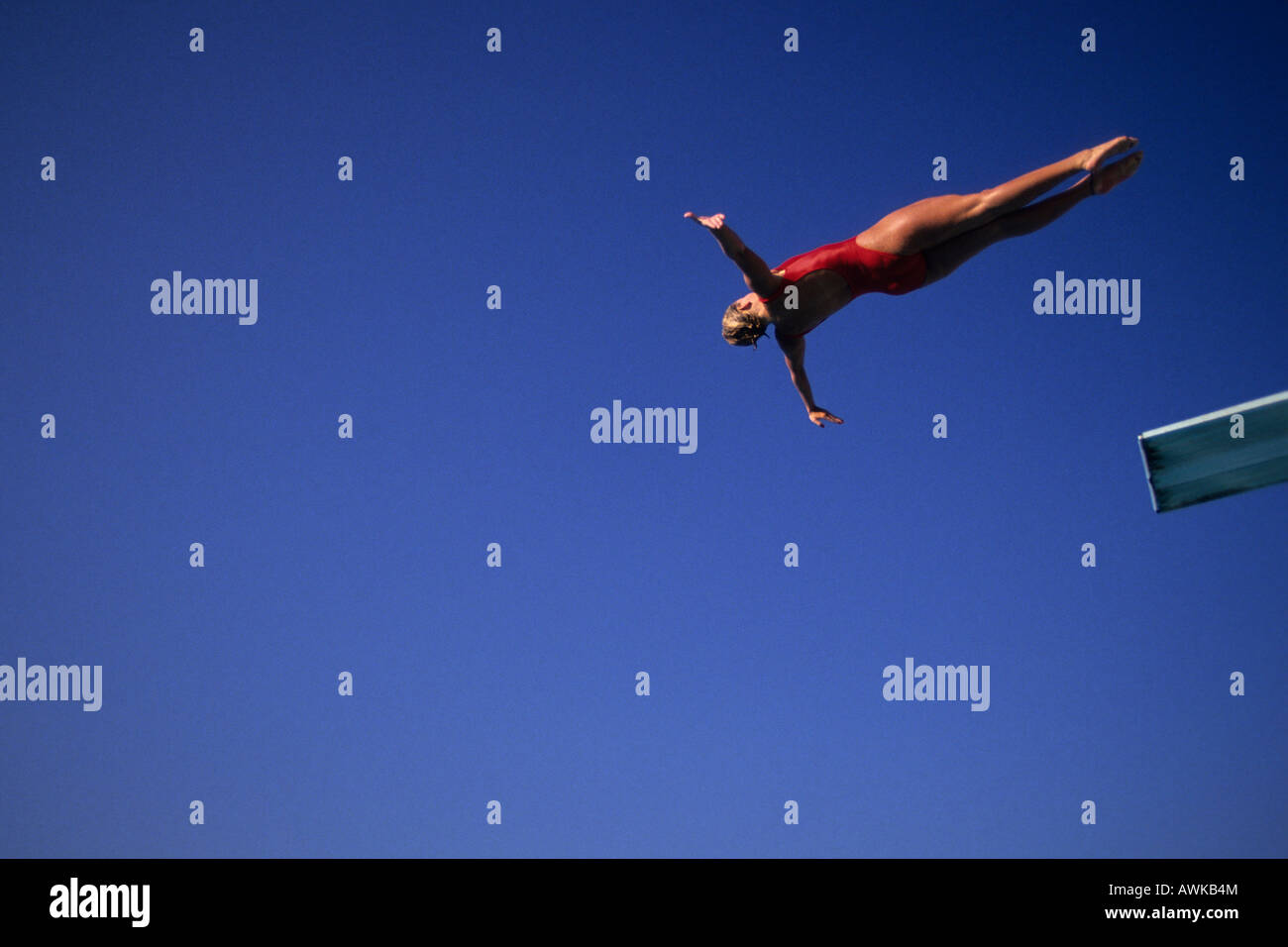 Woman diver flying through the air Stock Photo - Alamy