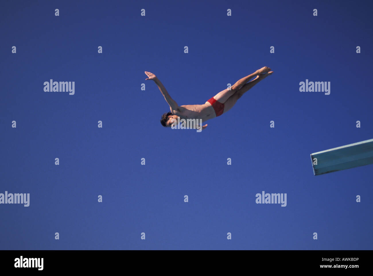 Young male diver flying off the springboard Stock Photo - Alamy