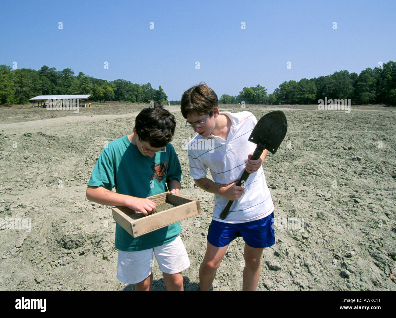 Two boys dig in the dried mud for real diamonds at Crater Of Diamonds ...