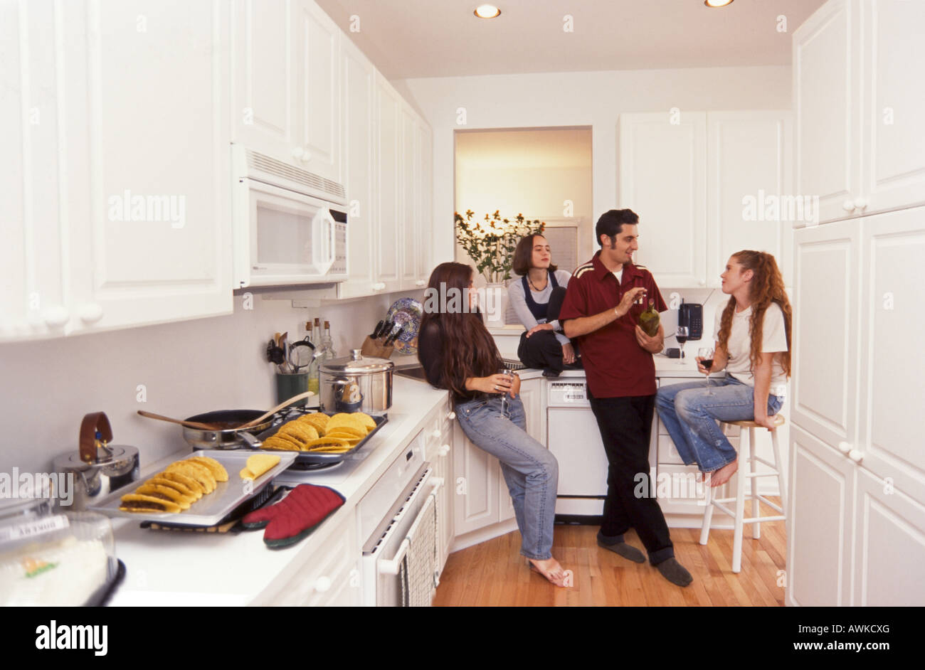 Gen x 2 having a dinner party, laughing, having fun Stock Photo - Alamy