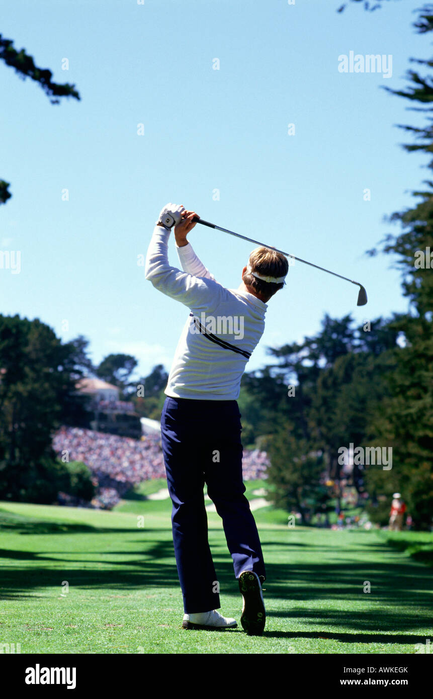 Rear view of male golfer driving down the fairway Stock Photo - Alamy
