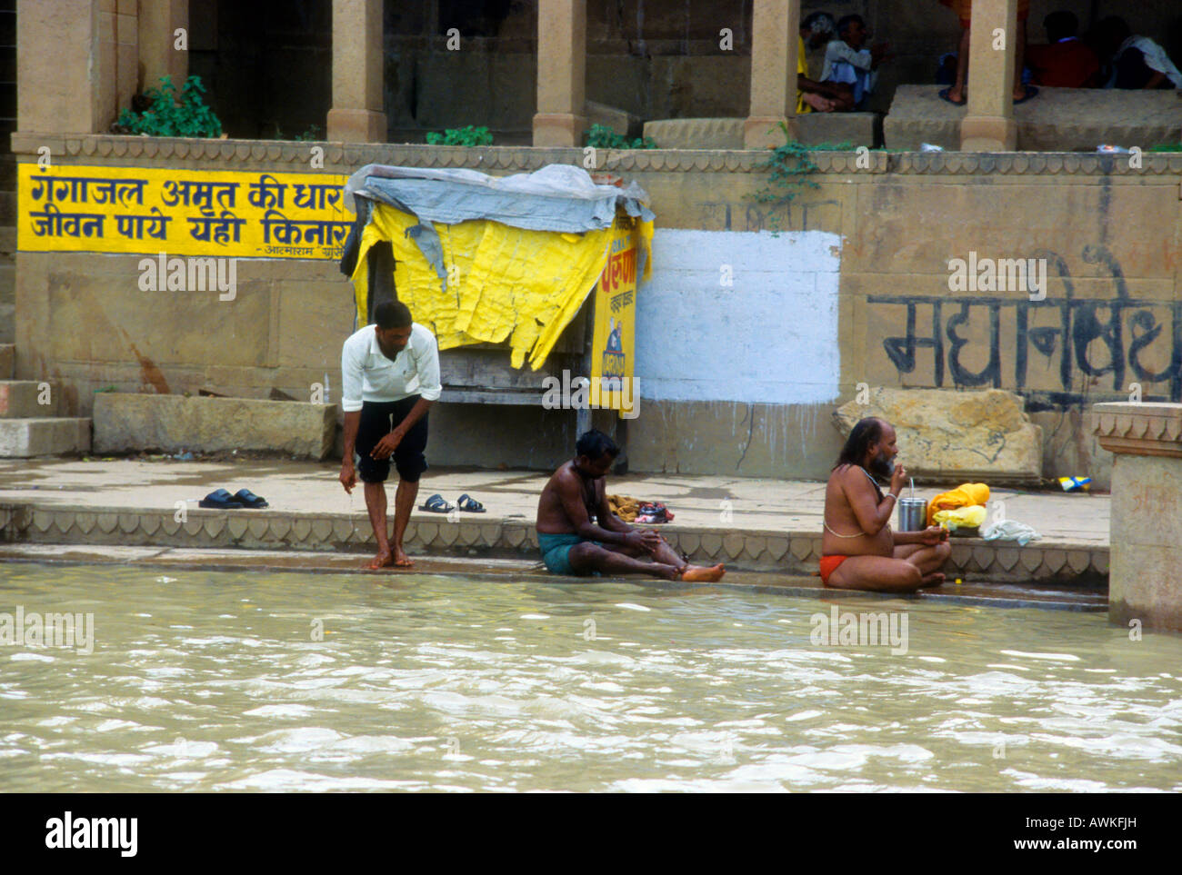 Hindu pilgrims bathing in ganges river on ghat at varanasi hi-res stock ...