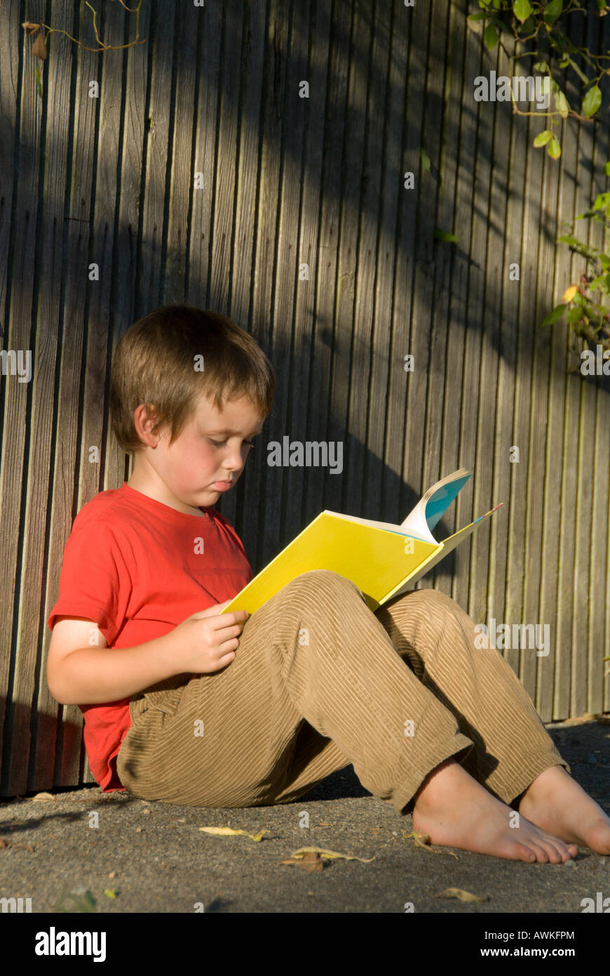 boy reading book outdoors Stock Photo - Alamy