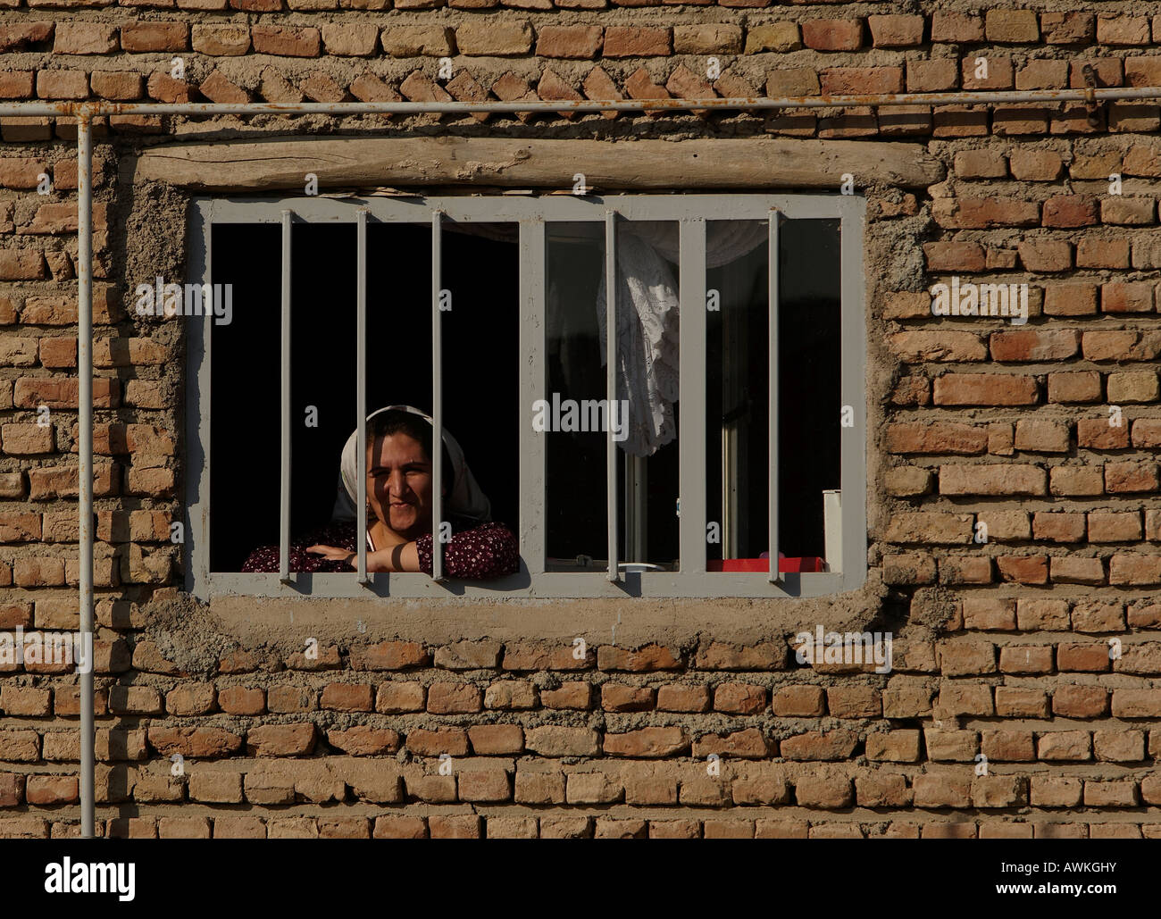 Woman behind window bars hi-res stock photography and images - Alamy