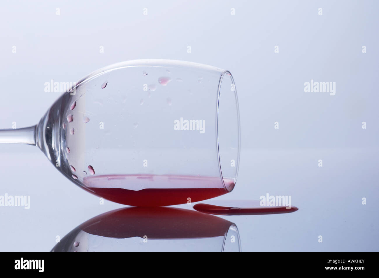 Glass spilling wine Stock Photo - Alamy