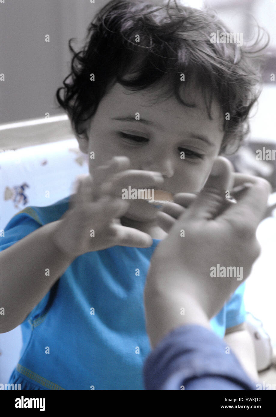 Person feeding young child Stock Photo - Alamy