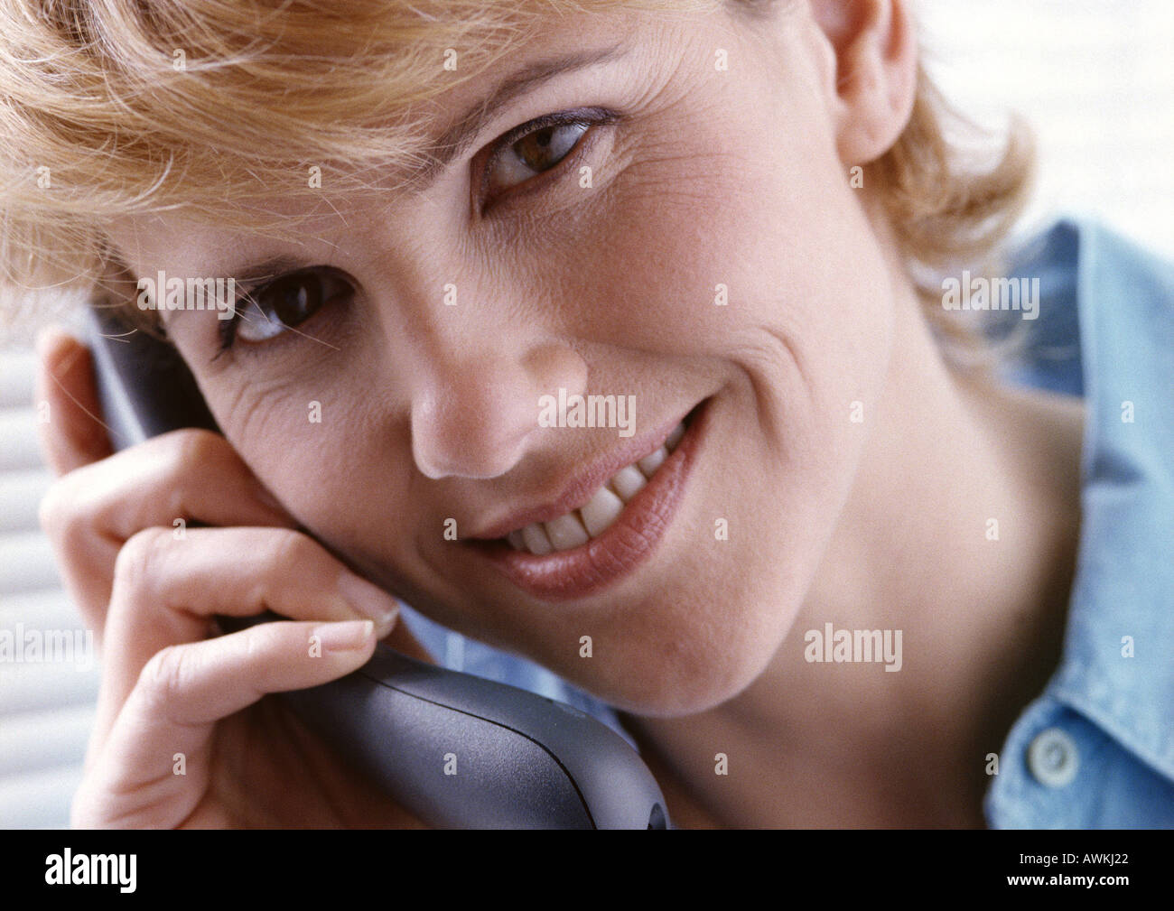 Woman on telephone facing camera Stock Photo - Alamy