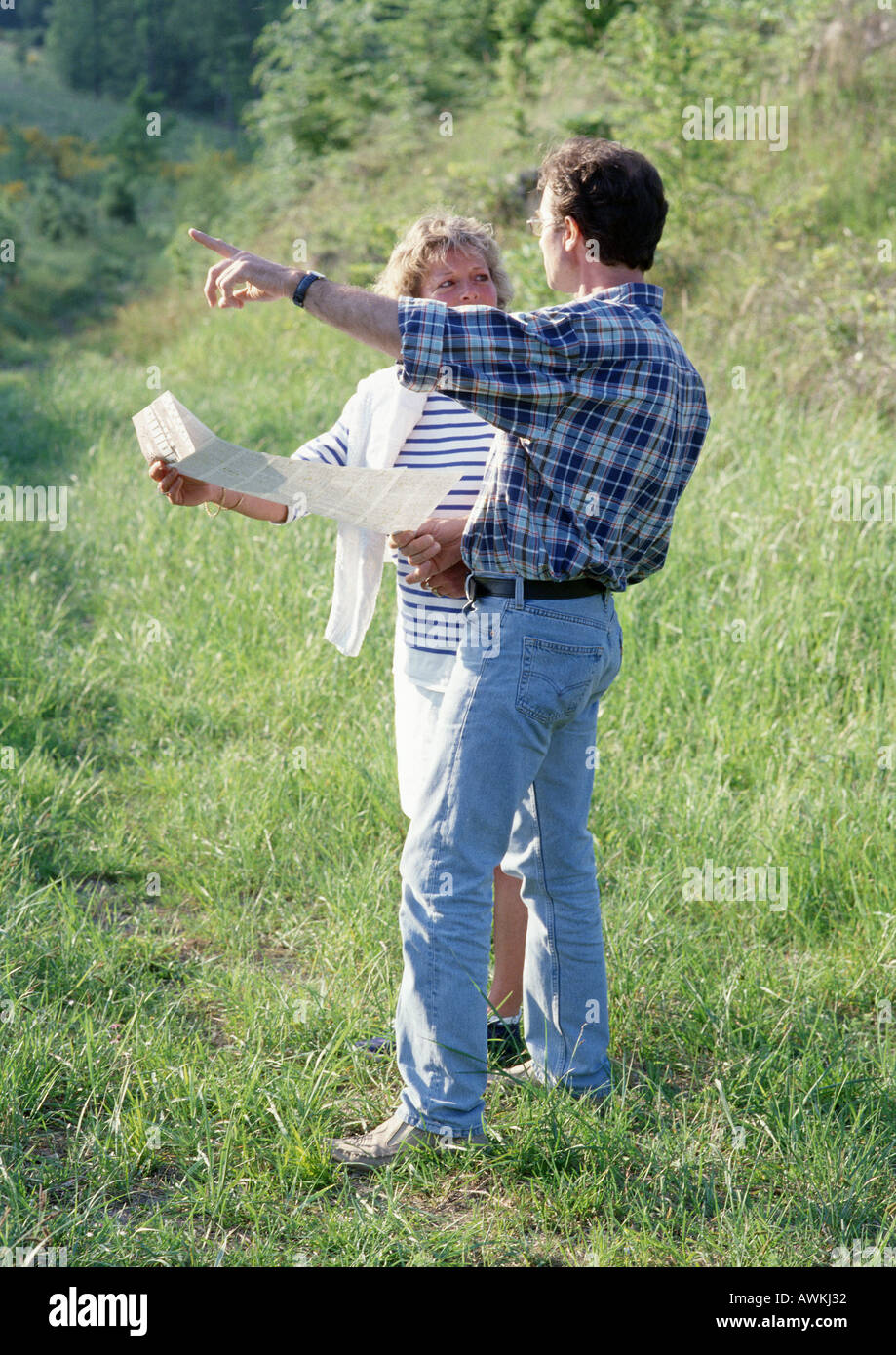 Couple looking at map, man pointing Stock Photo - Alamy