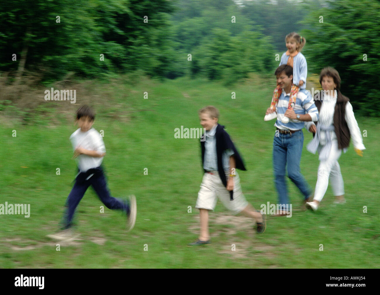 Family walking together outside Stock Photo - Alamy