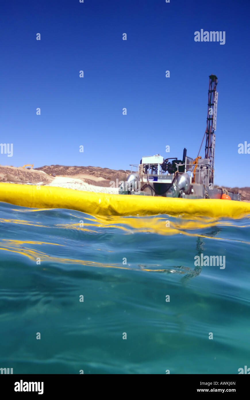 Dredge operating inside silt curtain protecting marine environment from ...