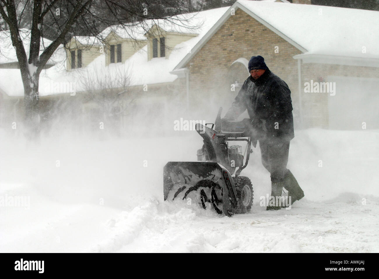 Man using snowblower Stock Photo - Alamy