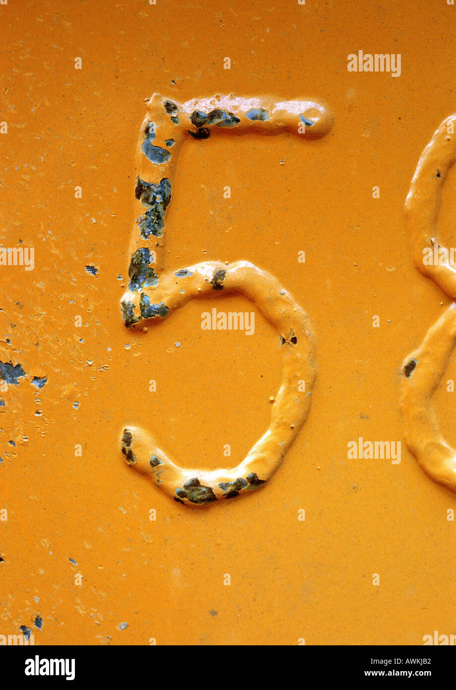 5 text embossed on chipped orange surface Stock Photo - Alamy