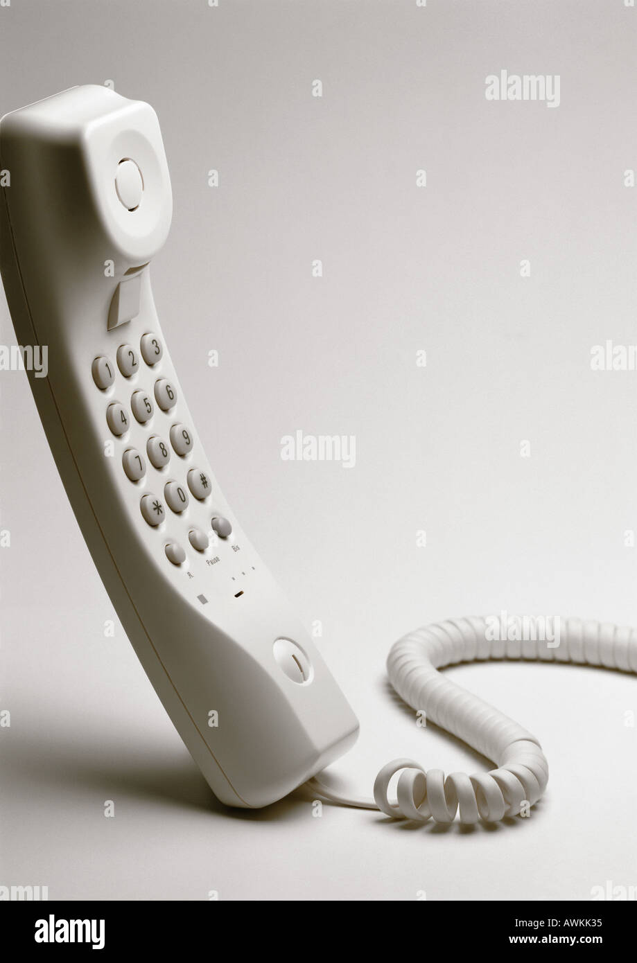 White telephone receiver standing on end, close-up Stock Photo - Alamy