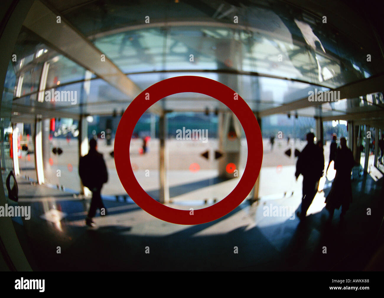 People walking, red circle on glass in foreground Stock Photo - Alamy