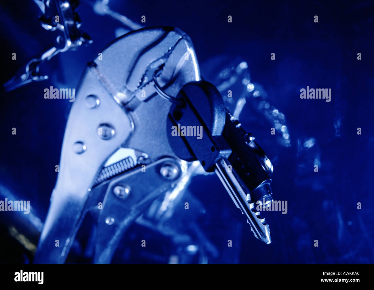 Wrench holding keys Stock Photo - Alamy