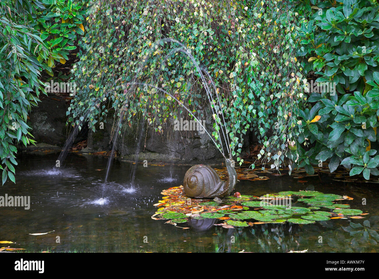 A charming fountain in the form of a snail in a small pond Stock Photo ...