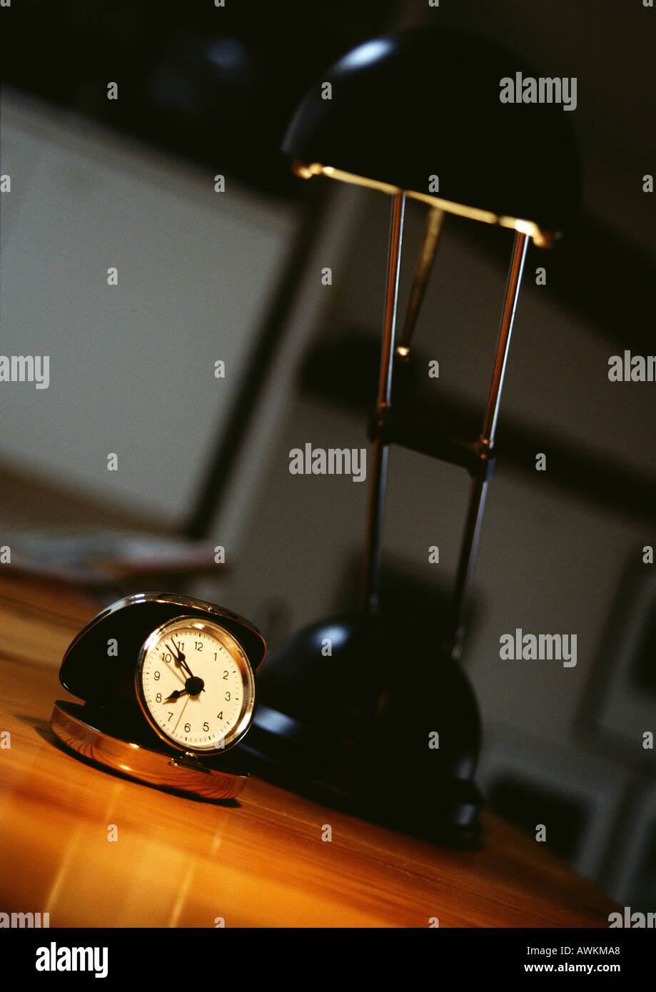 Alarm clock and desk lamp on desk Stock Photo - Alamy