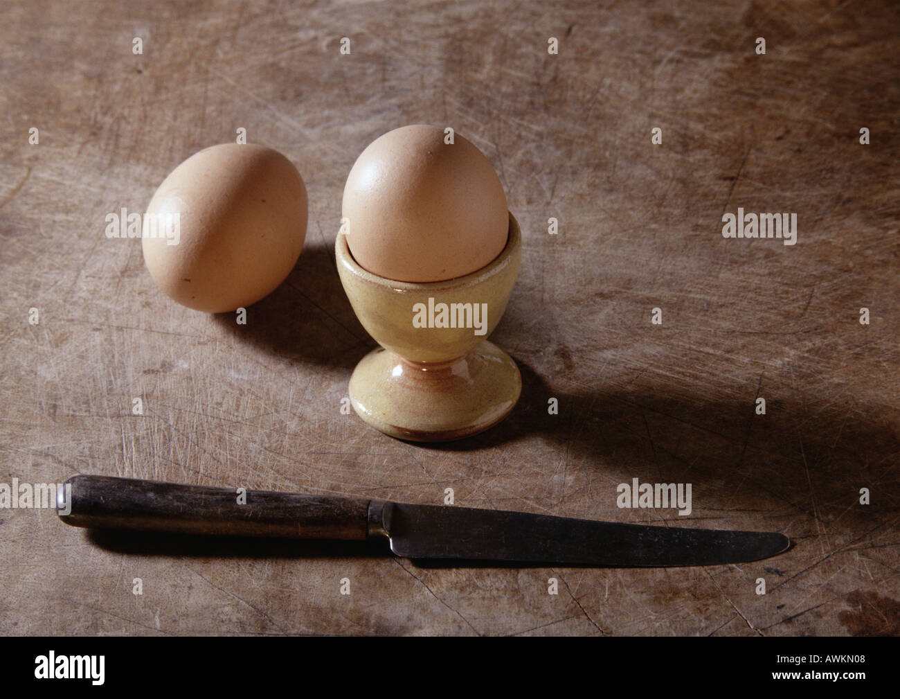 Eggs, eggcup and knife Stock Photo - Alamy