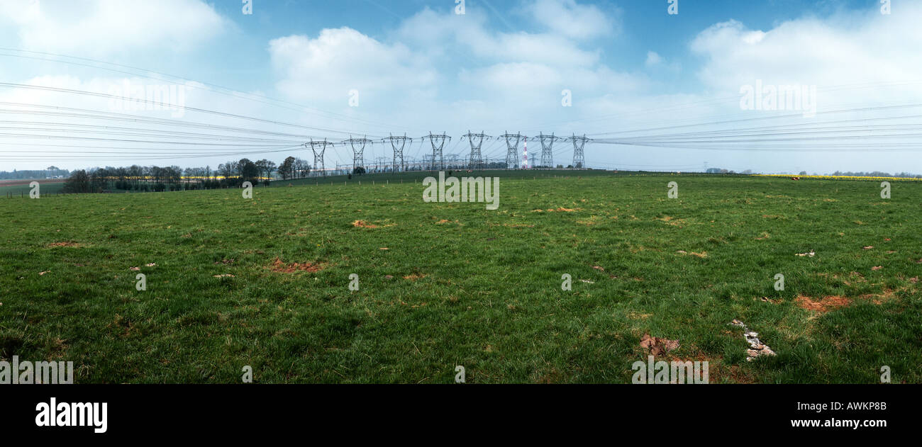 Rural field with row of power lines in the distance, France Stock Photo ...
