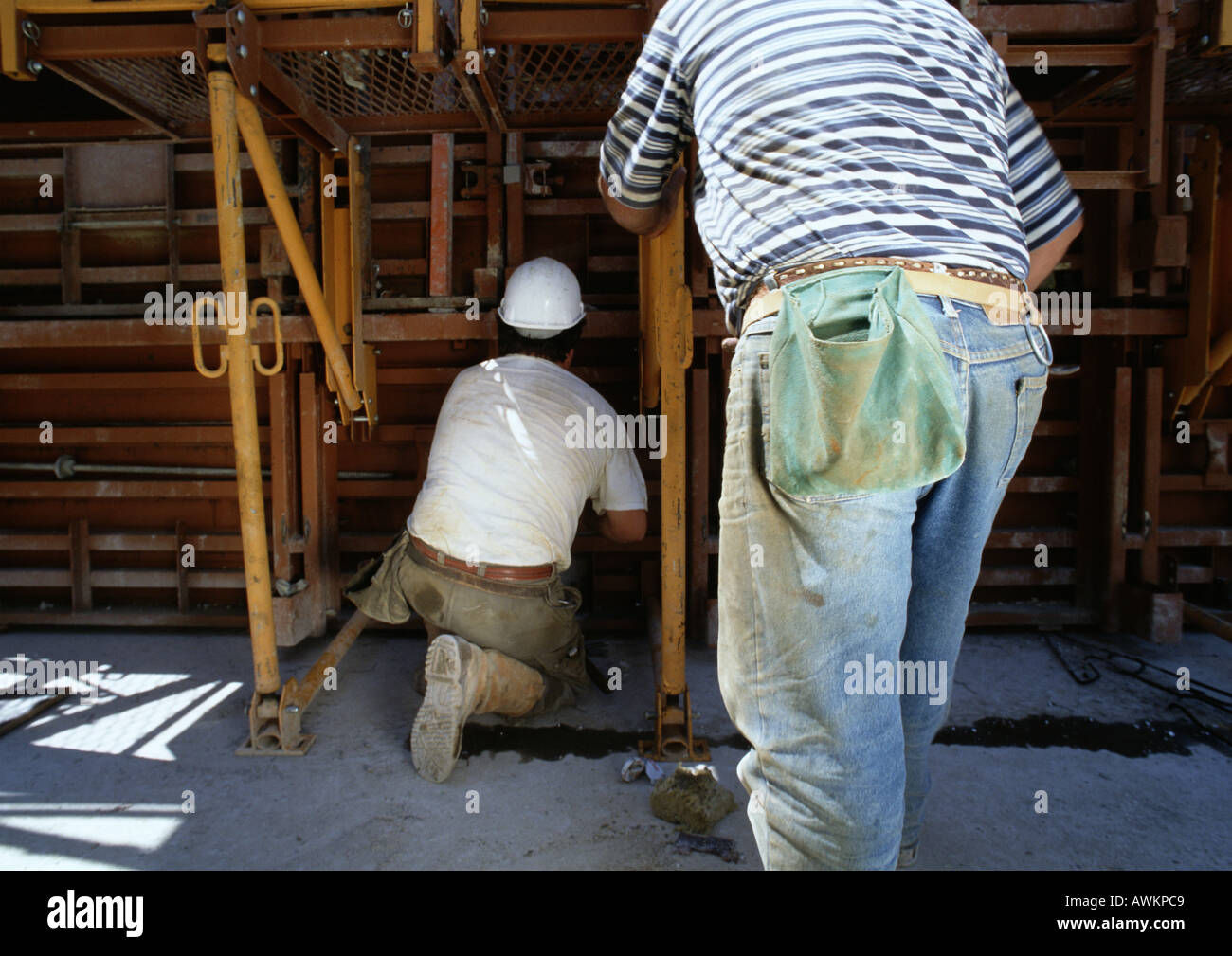 Two workers in construction site, rear view Stock Photo - Alamy