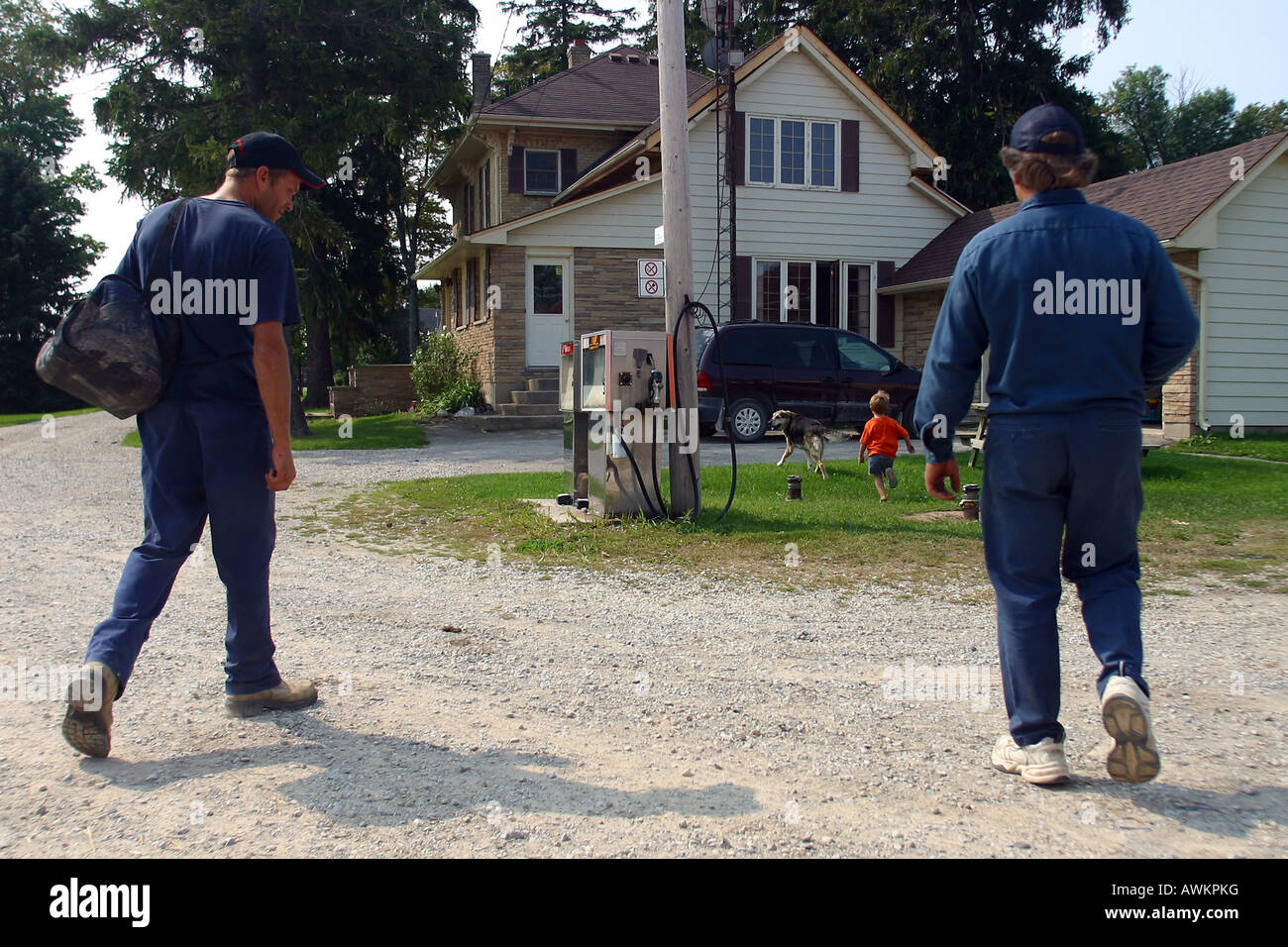 Two farmers head in for lunch Stock Photo - Alamy