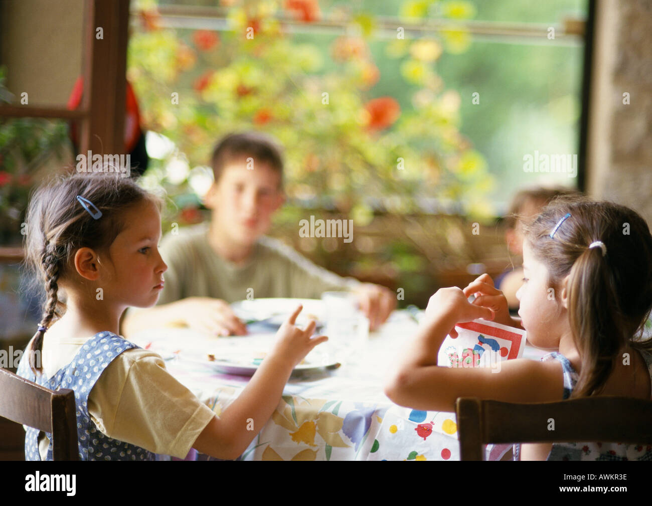 Children sitting around table Stock Photo - Alamy