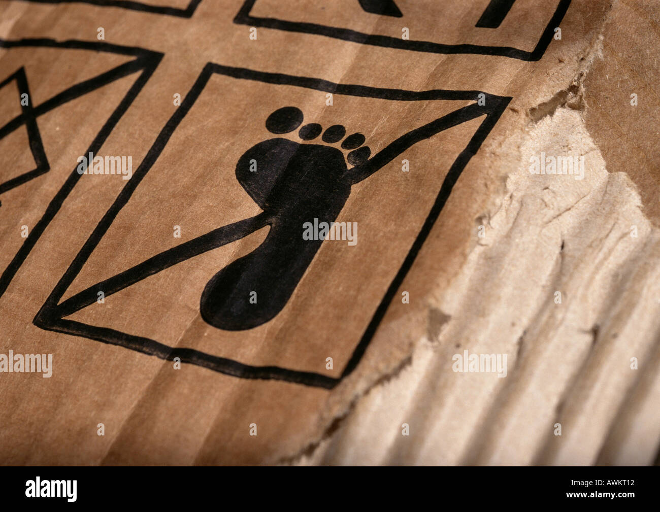 Warning sign with foot symbol on cardboard, close-up Stock Photo - Alamy