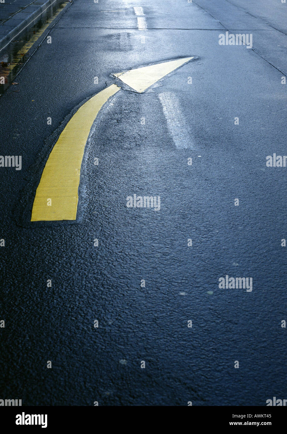Directional arrow on road, close-up Stock Photo - Alamy
