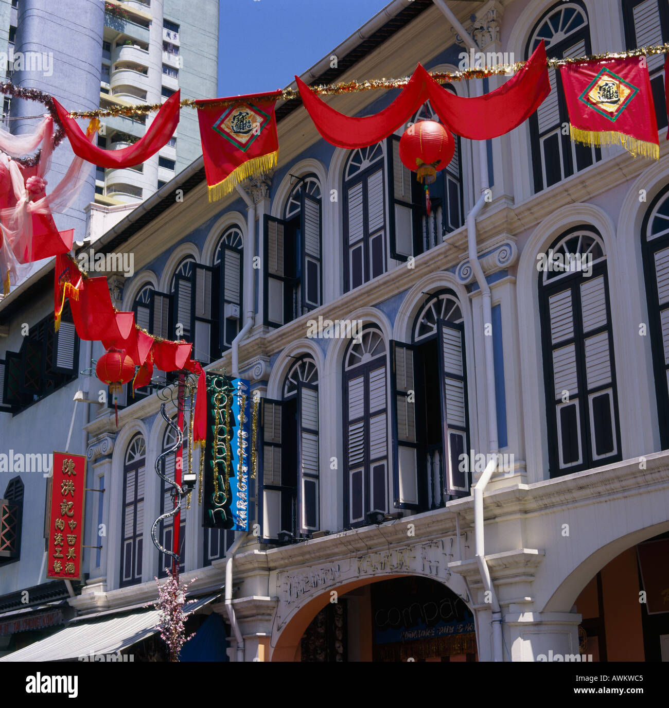 Row of attractive renovated colonial buildings with bright red flags ...