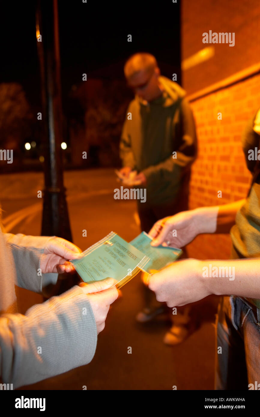 Ticket tout counts the cash after selling event tickets on a street ...