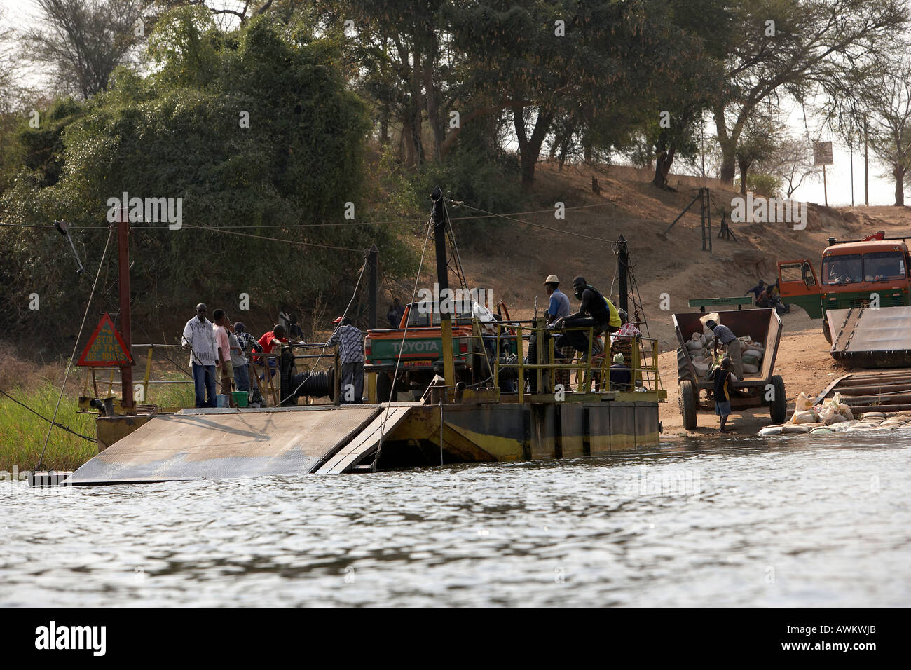 People and vehicle crossing the Kafue River on a pontoon Zambia Africa ...