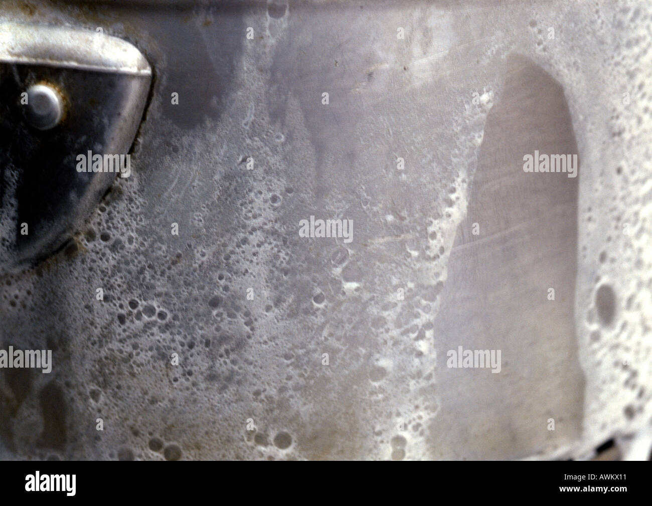 Milk boiling over saucepan, extreme close-up Stock Photo - Alamy