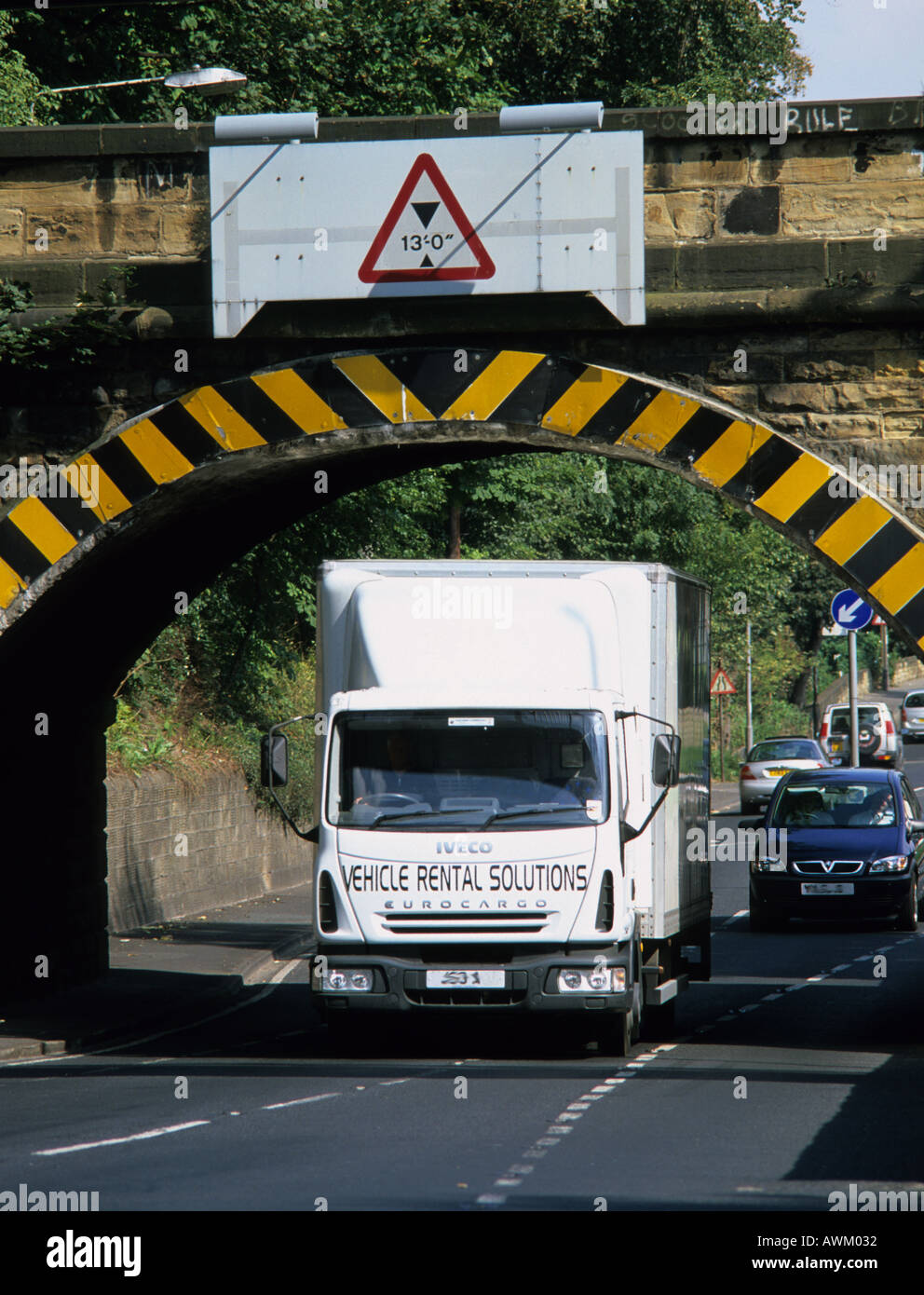 lorry passing under low railway bridge leeds uk Stock Photo - Alamy