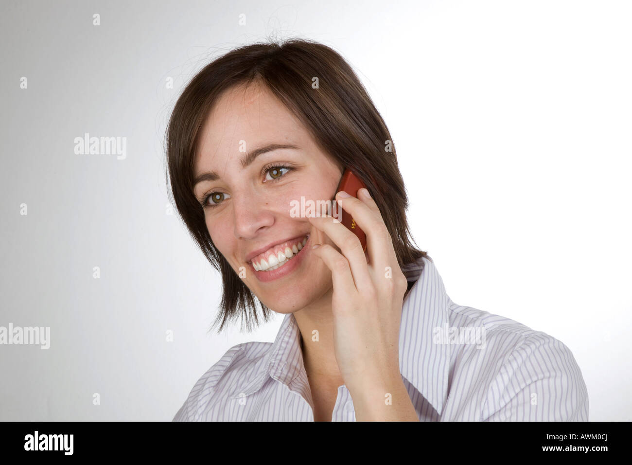 Young woman with cell phone, smiling Stock Photo - Alamy