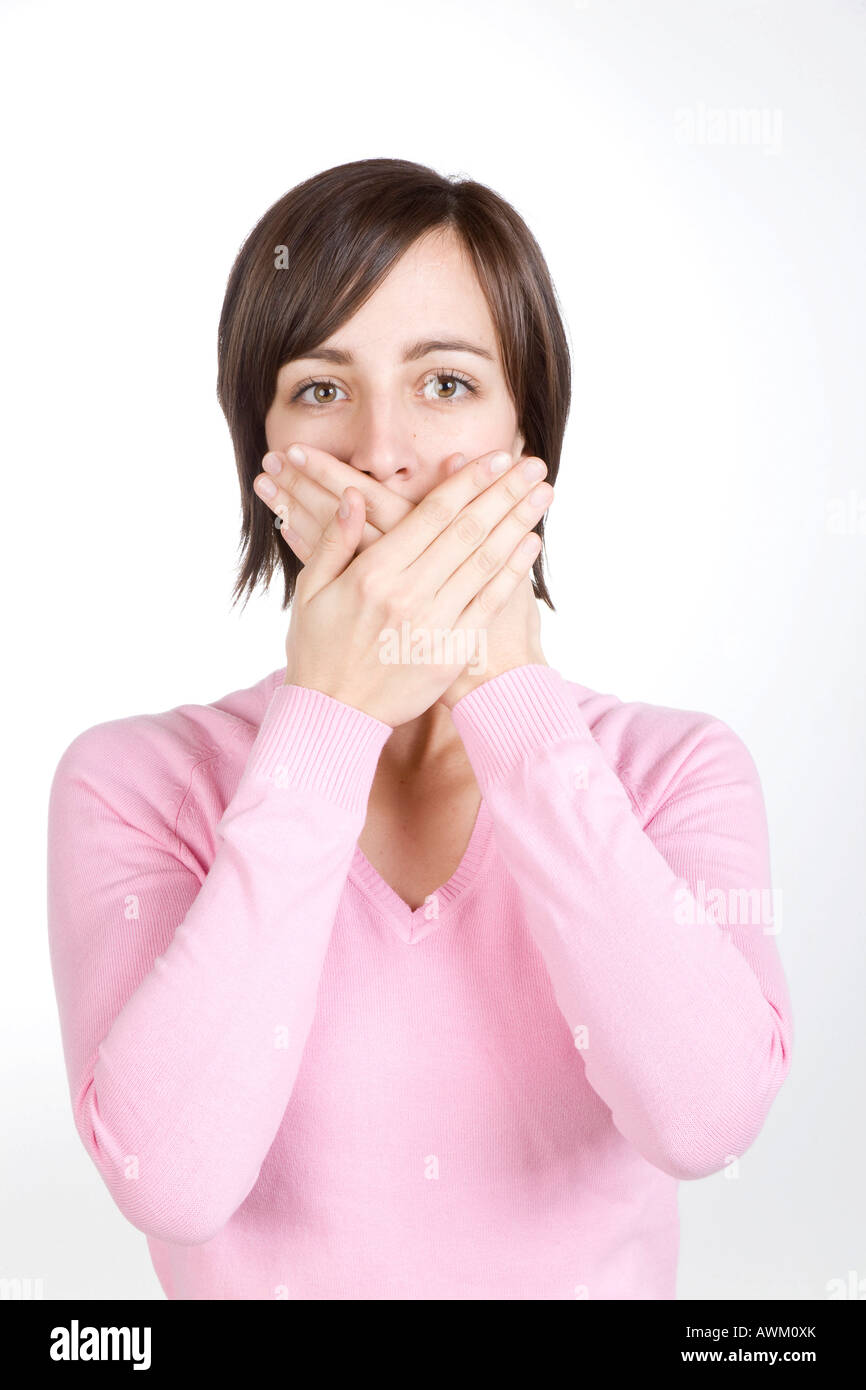 Young woman holding mouth shut hi-res stock photography and images - Alamy