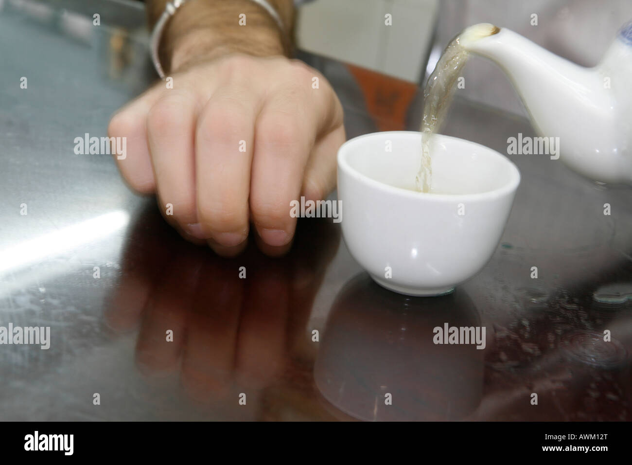 ritual of touching with fingers while pouring the tea Stock Photo - Alamy